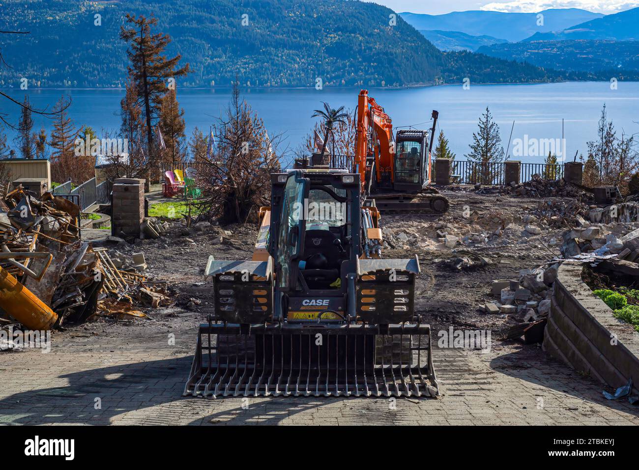 Photo of a bulldozer with what is left of a home burned in the Bush ...