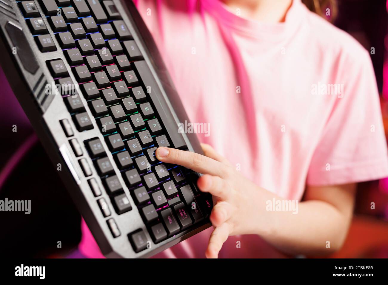 Close up shot of talented girl presenting latest gaming computer ...