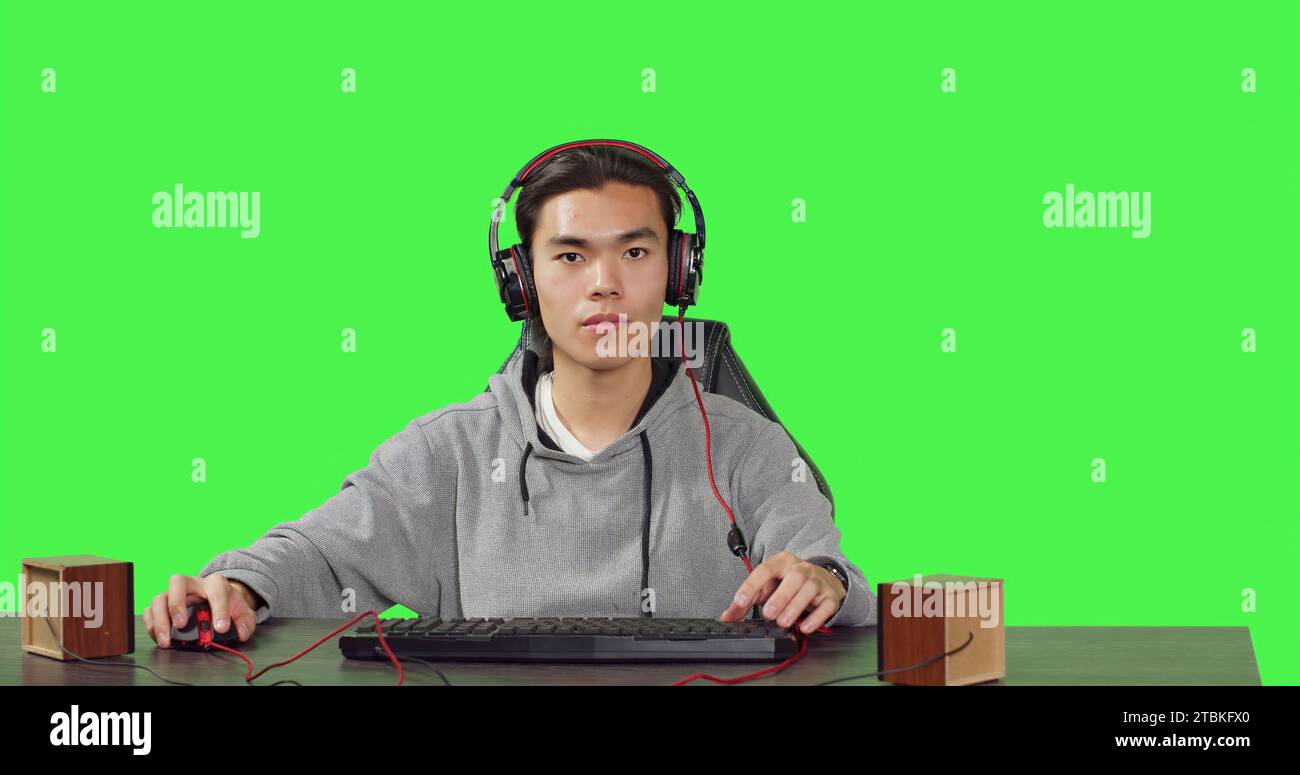 POV of asian man plays pc videogames at desk, sitting against ...