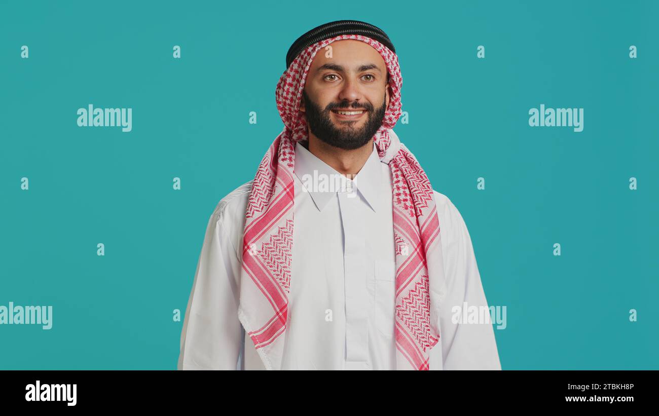 Middle eastern person gives thumbs up in front of camera, expressing ...