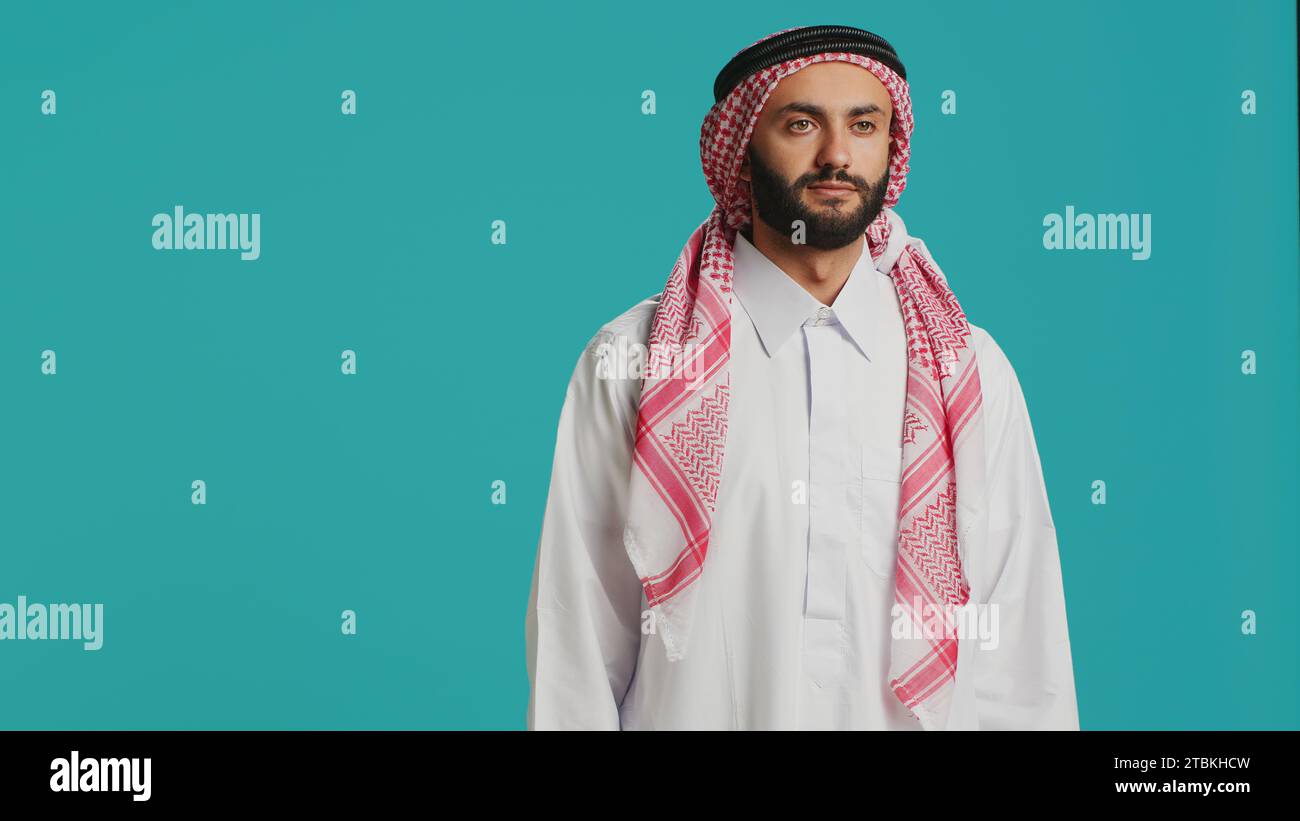 Middle eastern man in traditional attire smiling and posing with ...