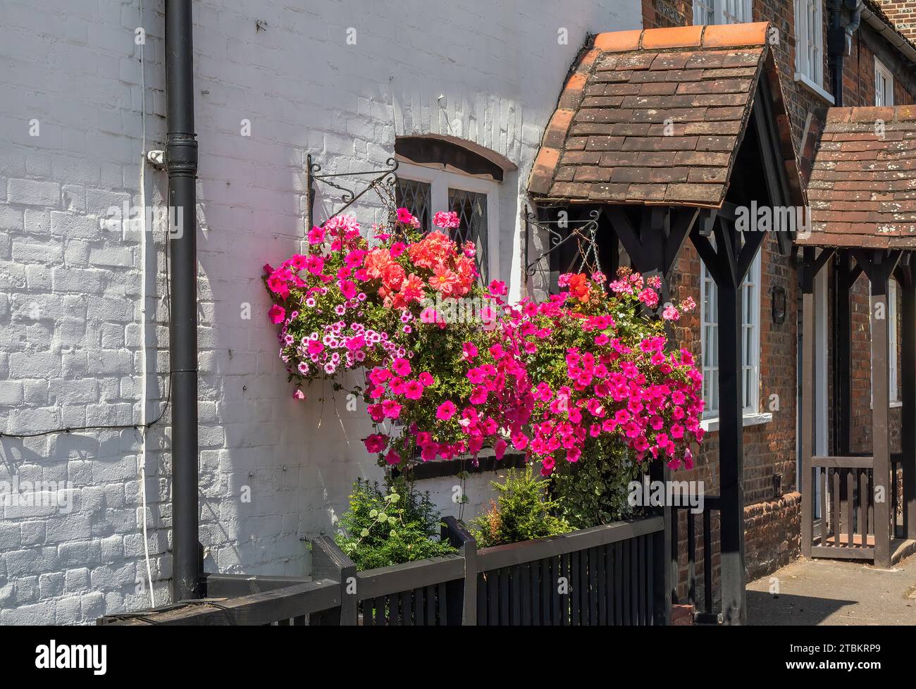 Beautiful hanging baskets outside a cottage Stock Photo - Alamy