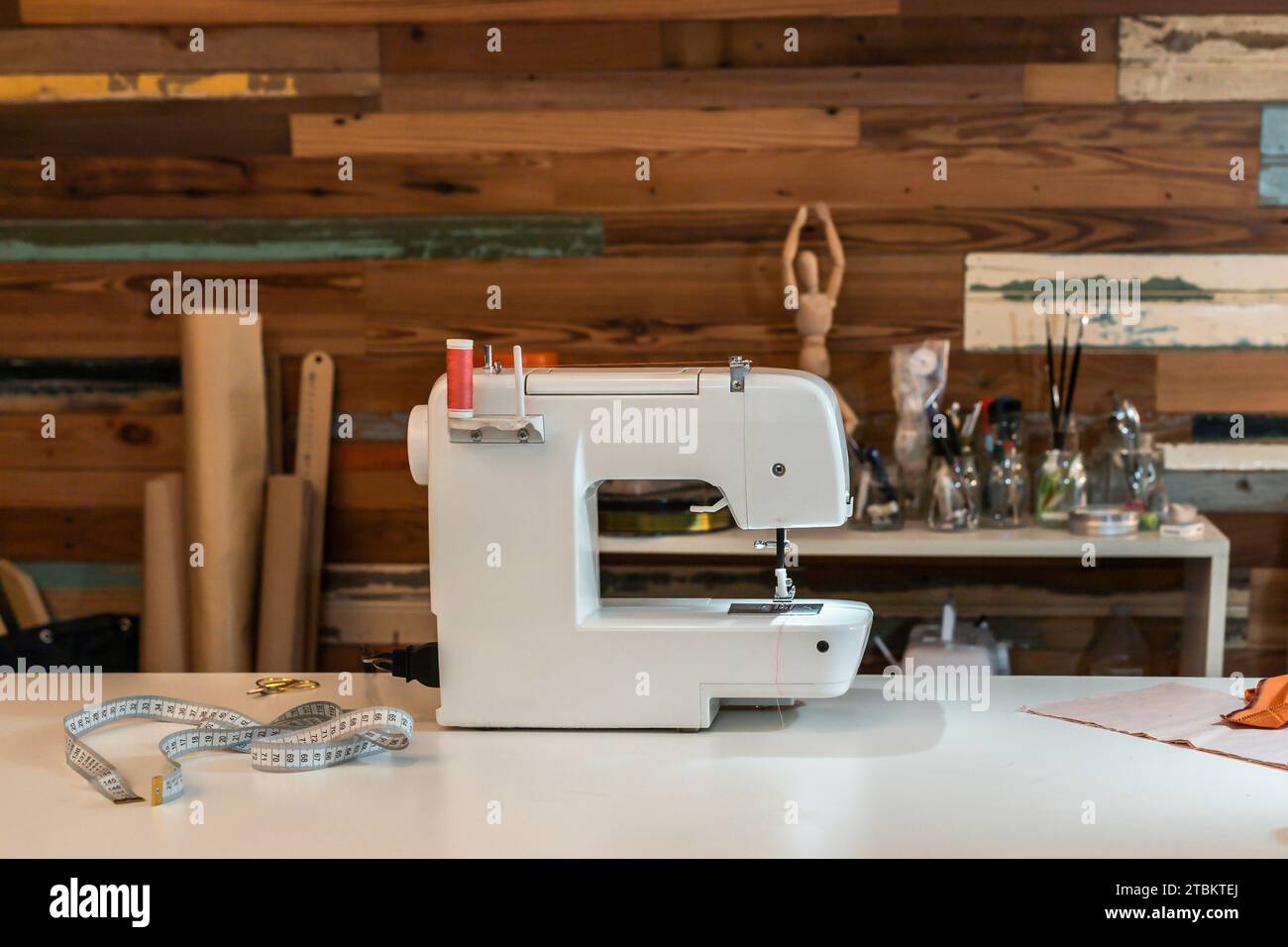 Modern sewing machine on table at fashion studio Stock Photo - Alamy