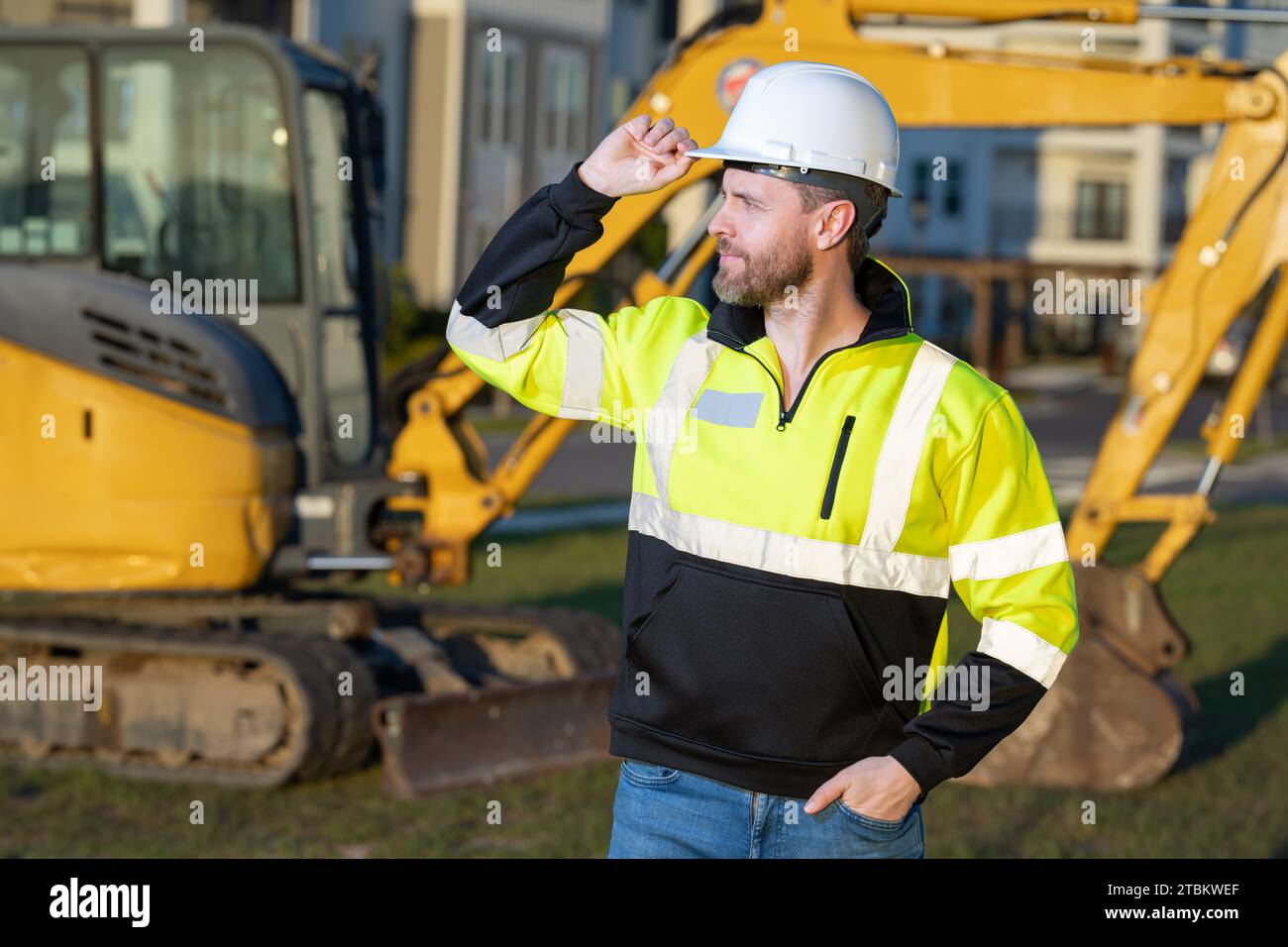 Builder with excavator for construction at the construction site ...