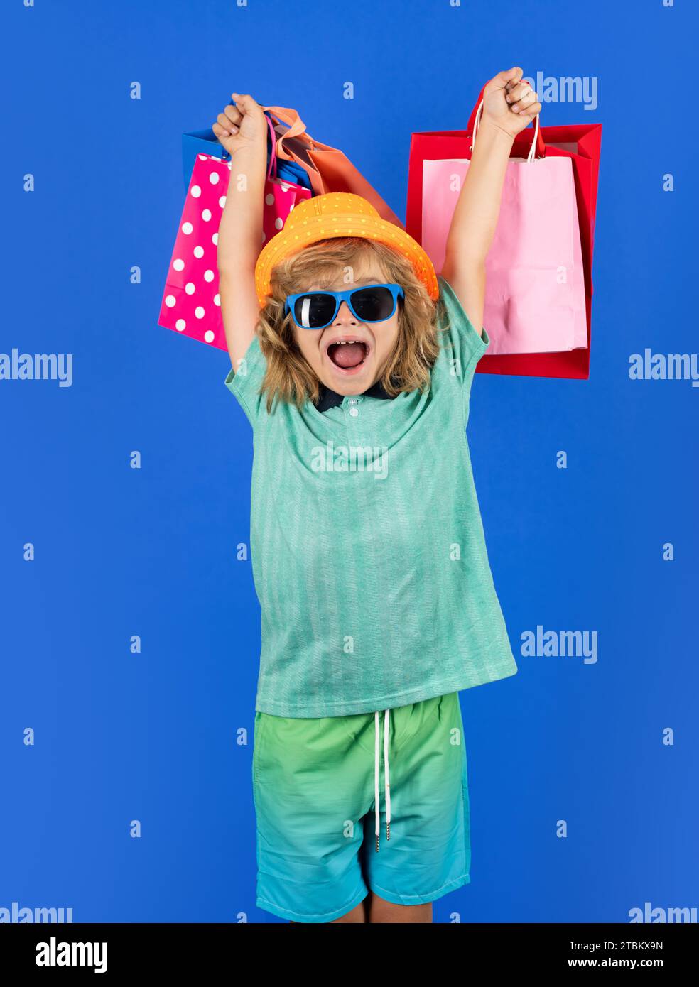 Fashion child on shopping. Portrait of a kid with shopping bags. Happy ...
