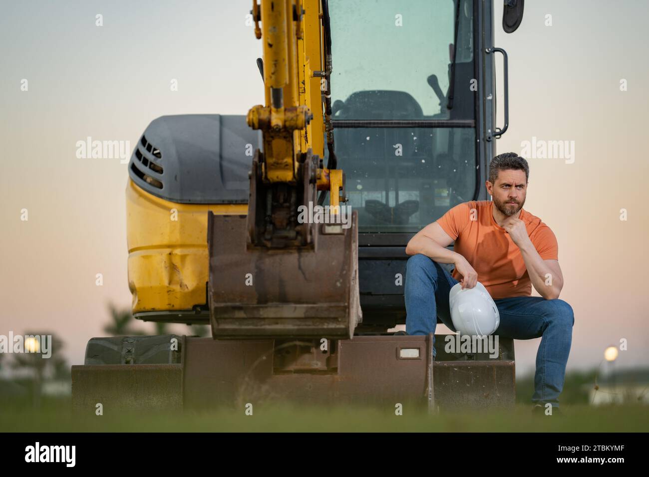 Worker with bulldozer on site construction. Man excavator worker ...