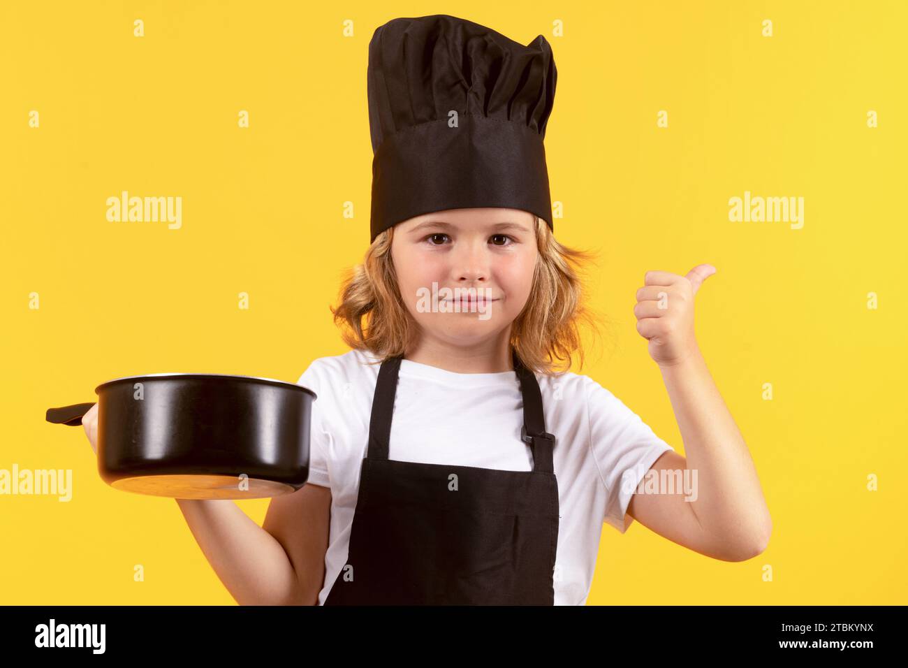 Funny kid chef cook with kitchen pot stockpot. Child in cook uniform ...