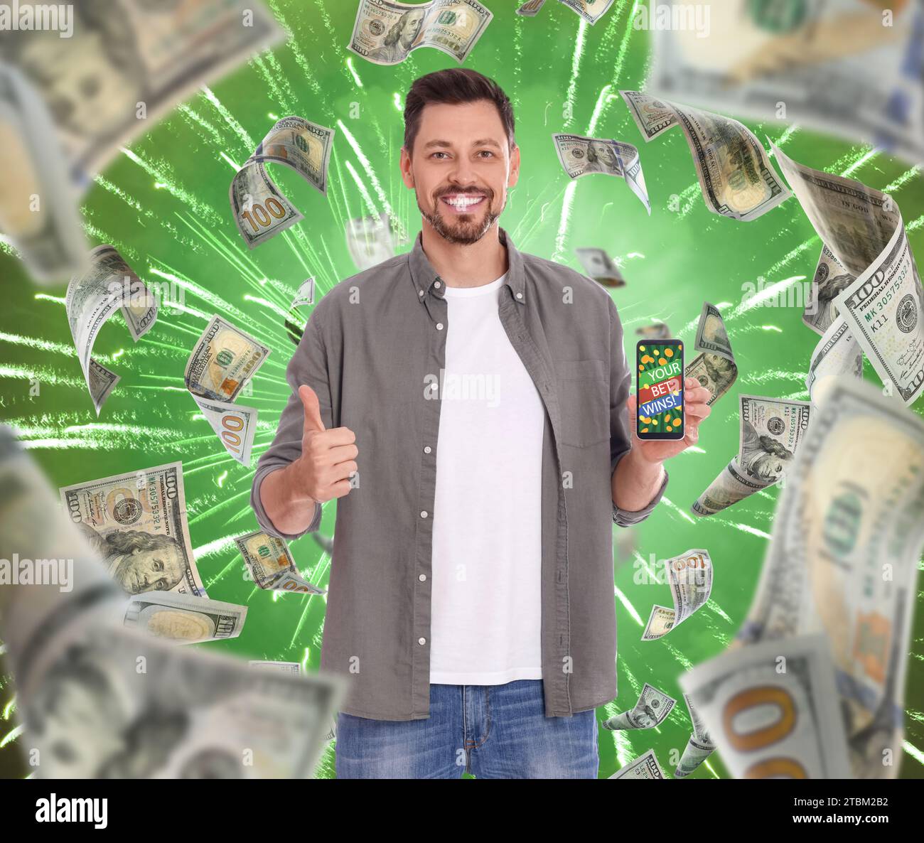 Your Bet Wins! Happy man holding smartphone and showing thumb up under ...