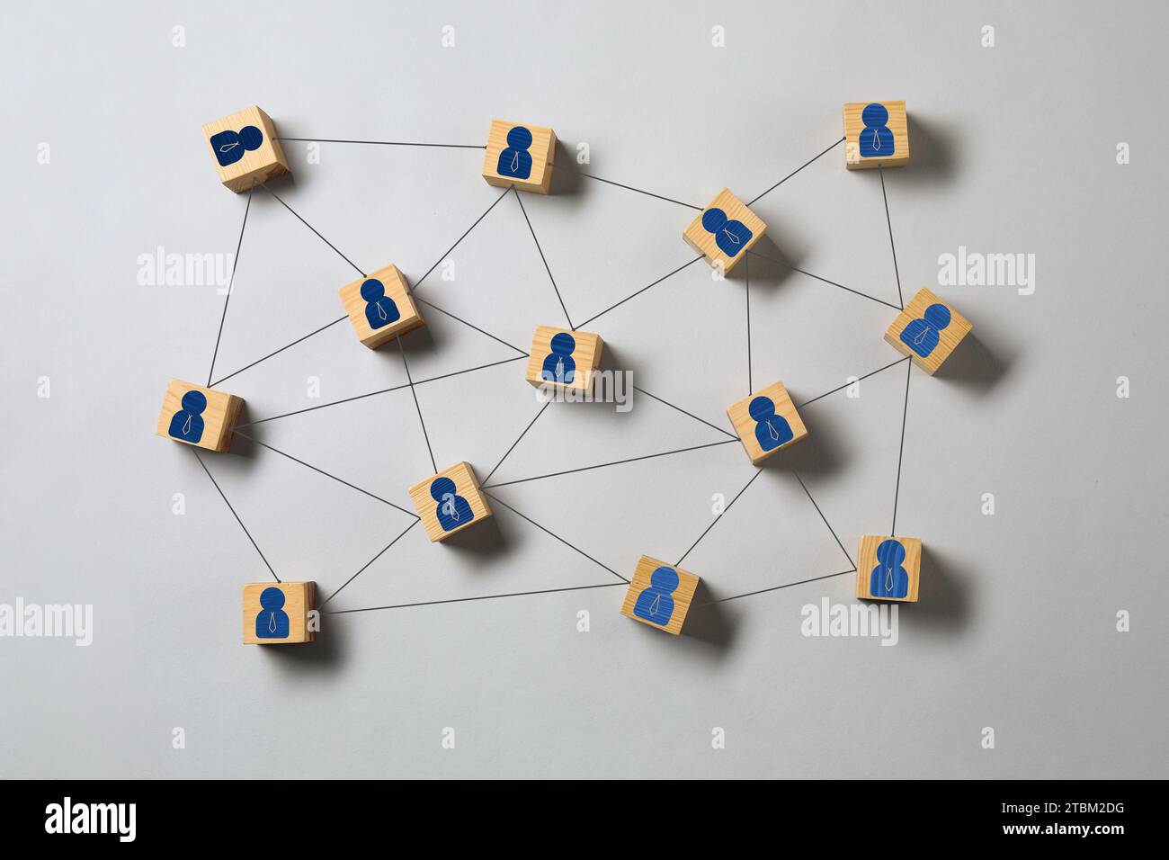 Teamwork. Wooden cubes with human icons linked together symbolizing ...