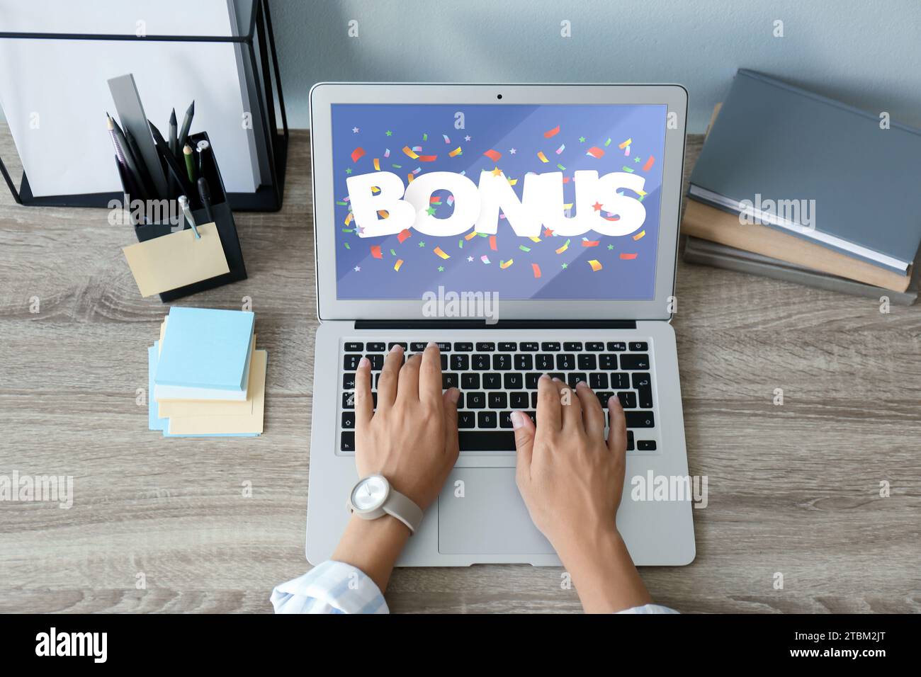 Bonus gaining. Woman using laptop at wooden table, above view ...