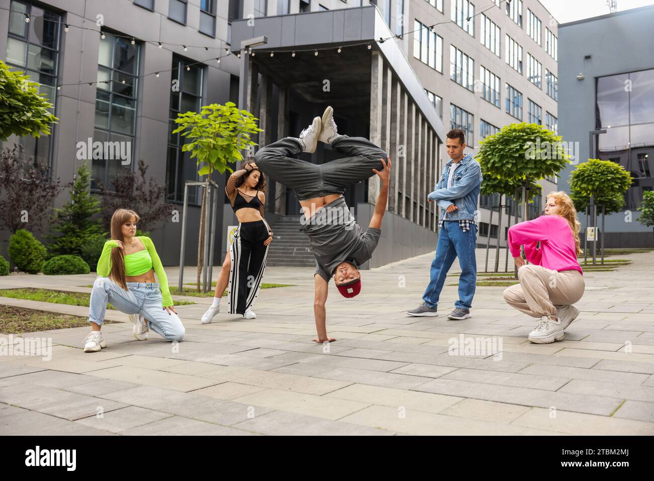 Group of people dancing hip hop outdoors, low angle view Stock Photo ...