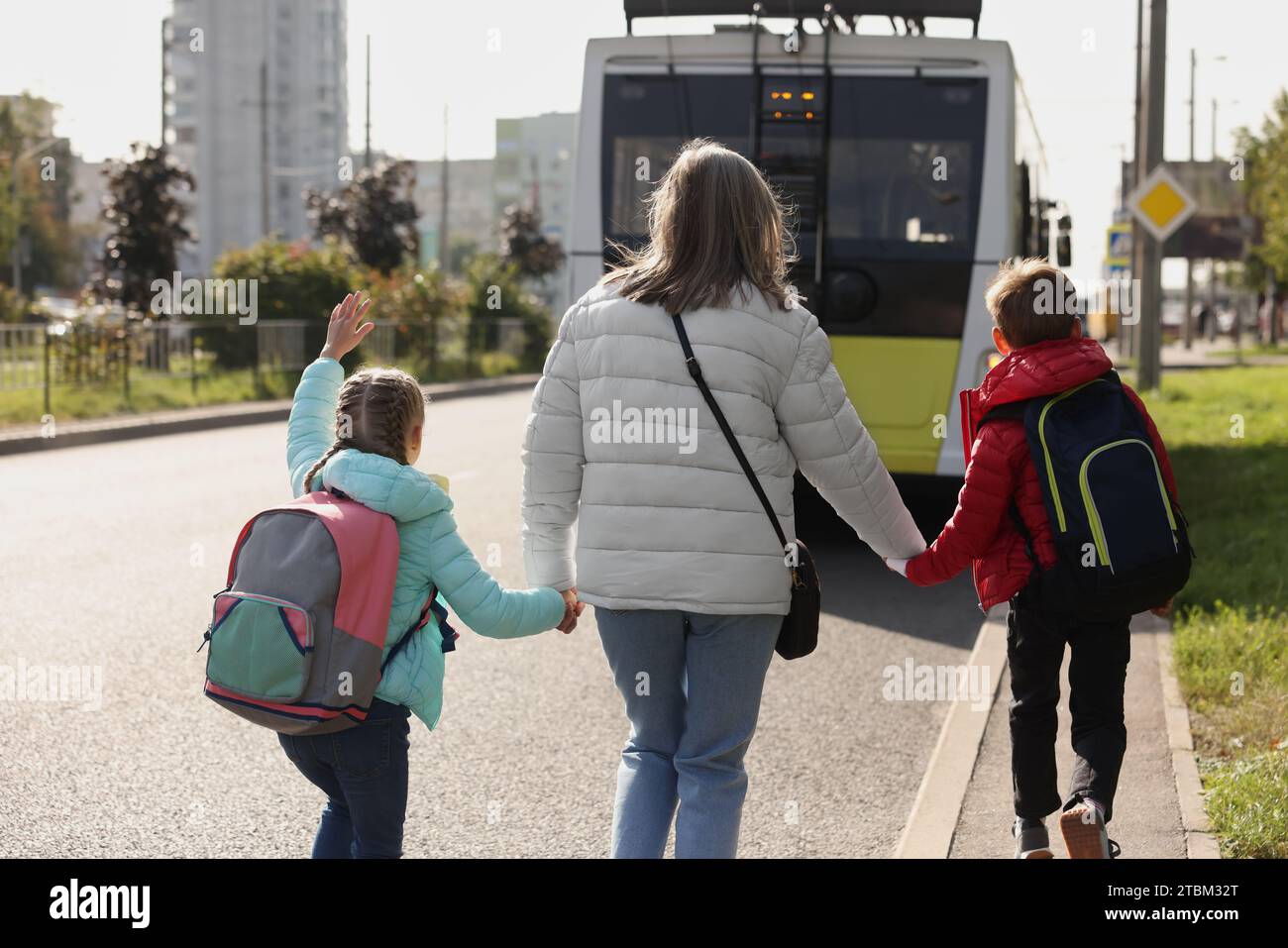 Being late for school. Senior woman and her grandchildren with ...