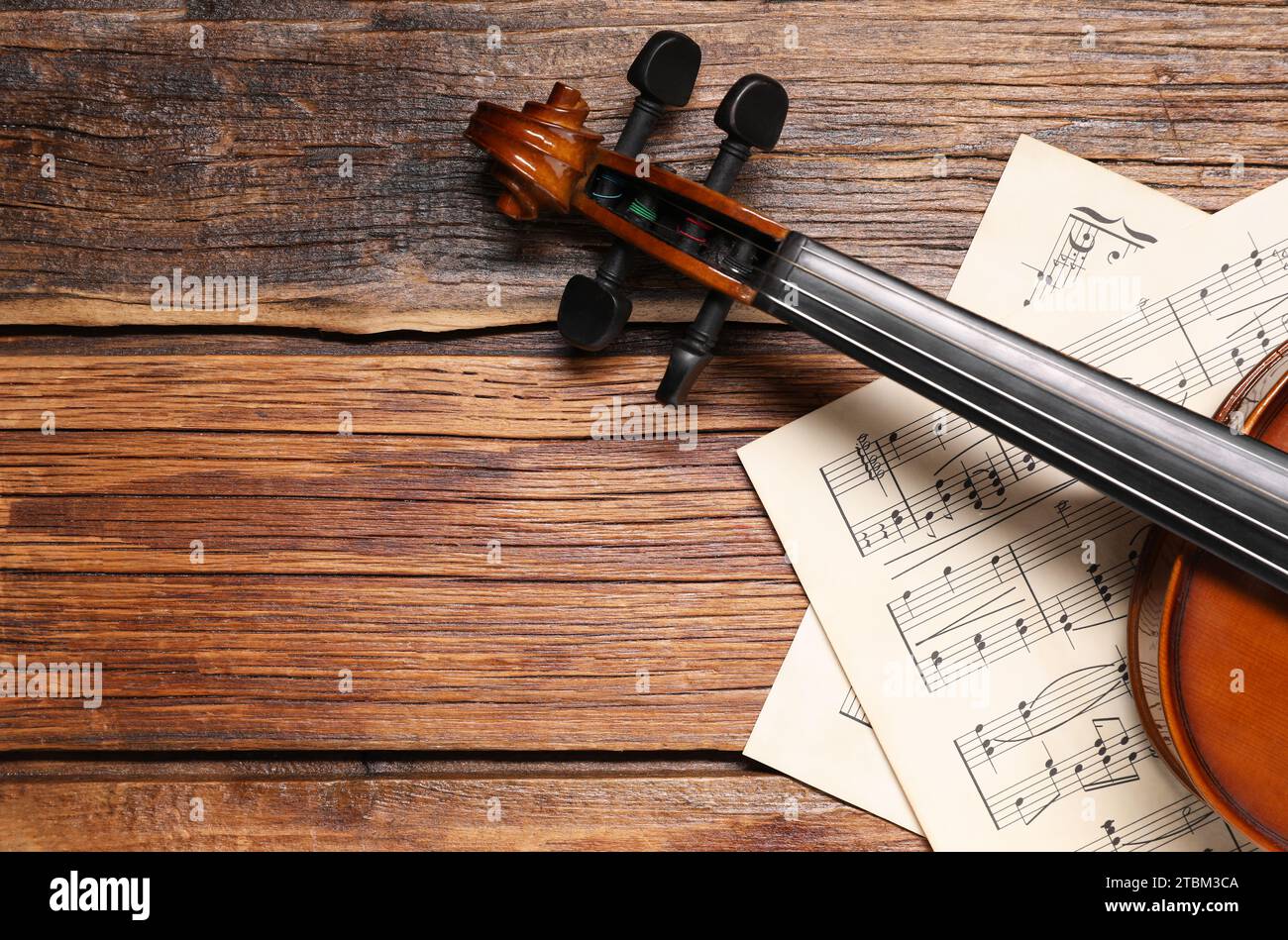 Violin and music sheets on wooden table, top view. Space for text Stock ...