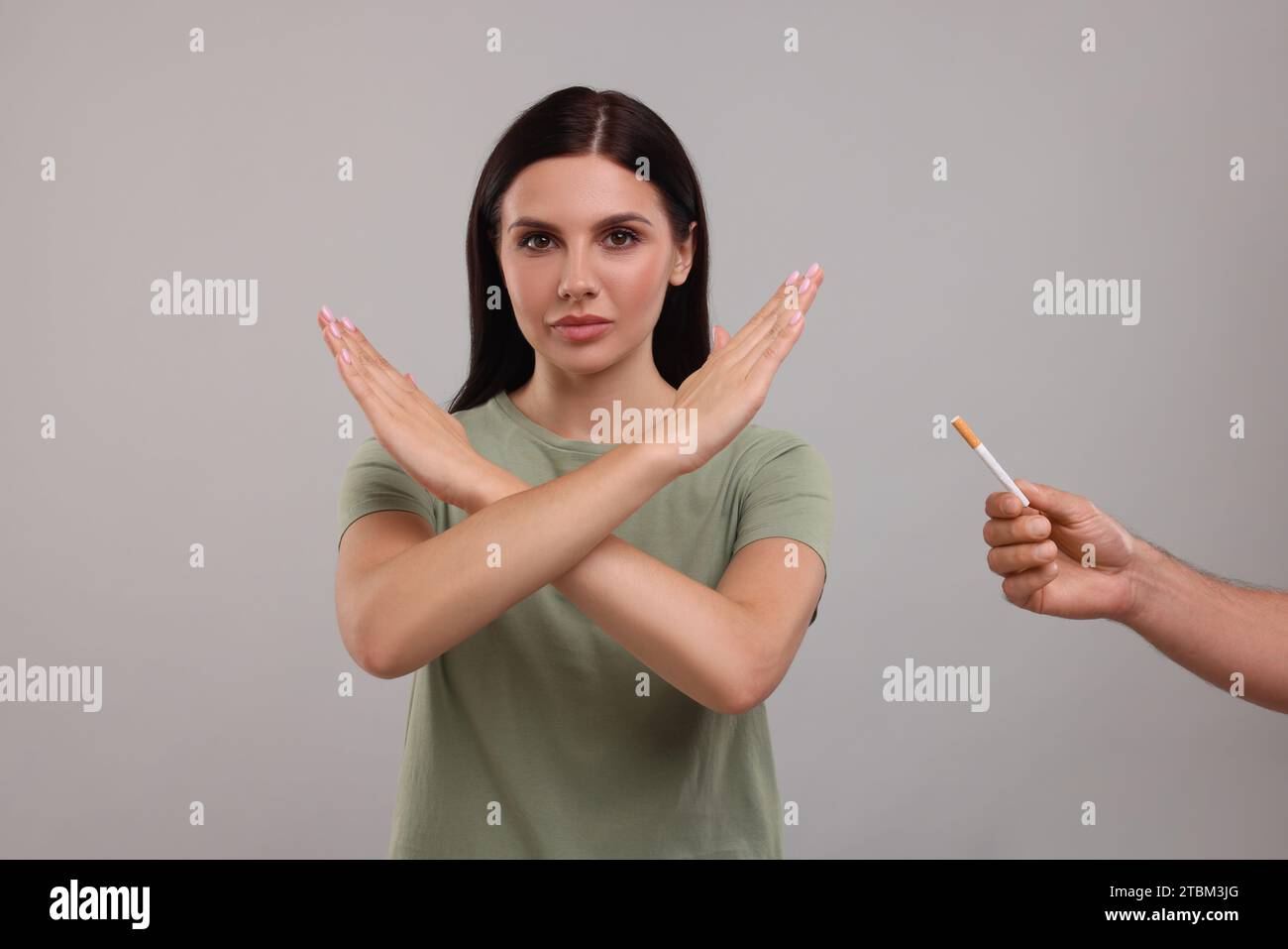 Stop smoking concept. Woman refusing cigarette on grey background Stock ...