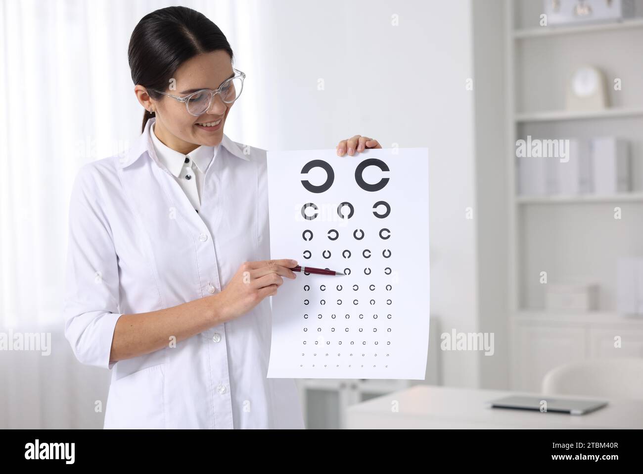 Ophthalmologist pointing at vision test chart in clinic Stock Photo - Alamy