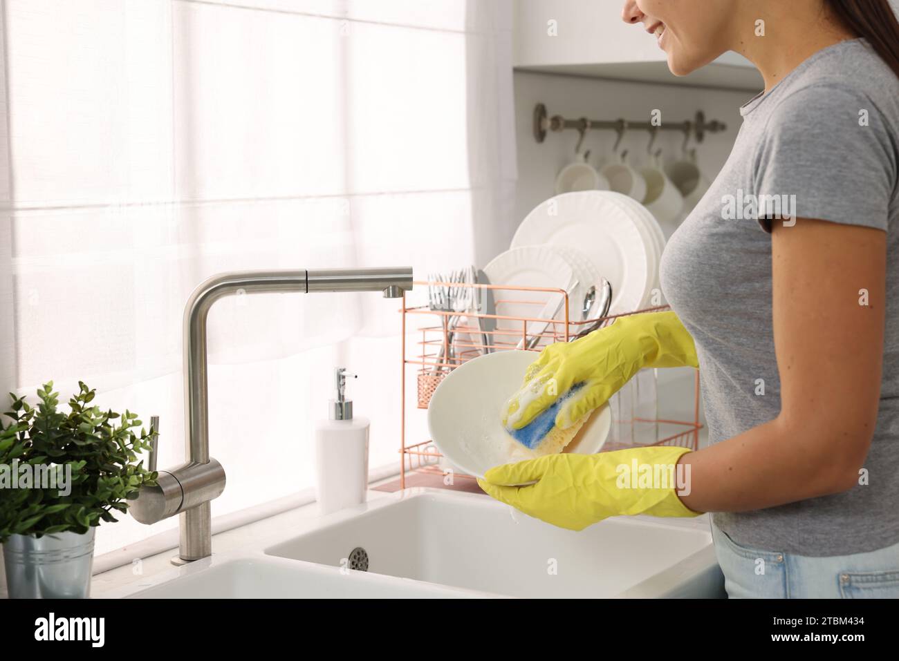 Woman washing bowl at sink in kitchen, closeup Stock Photo - Alamy