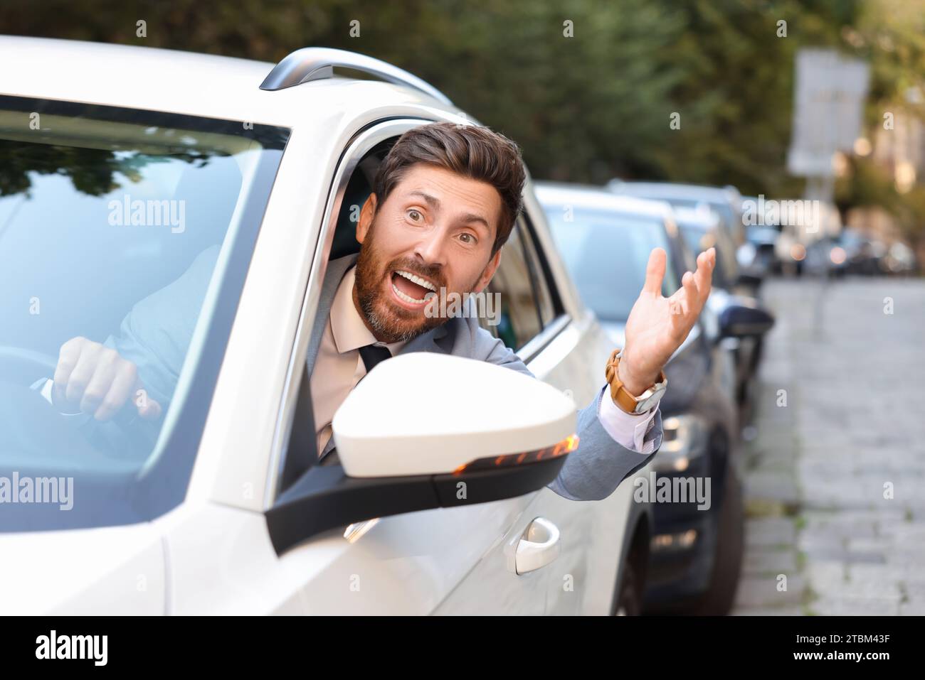 Angry driver screaming at someone from car in traffic jam Stock Photo ...