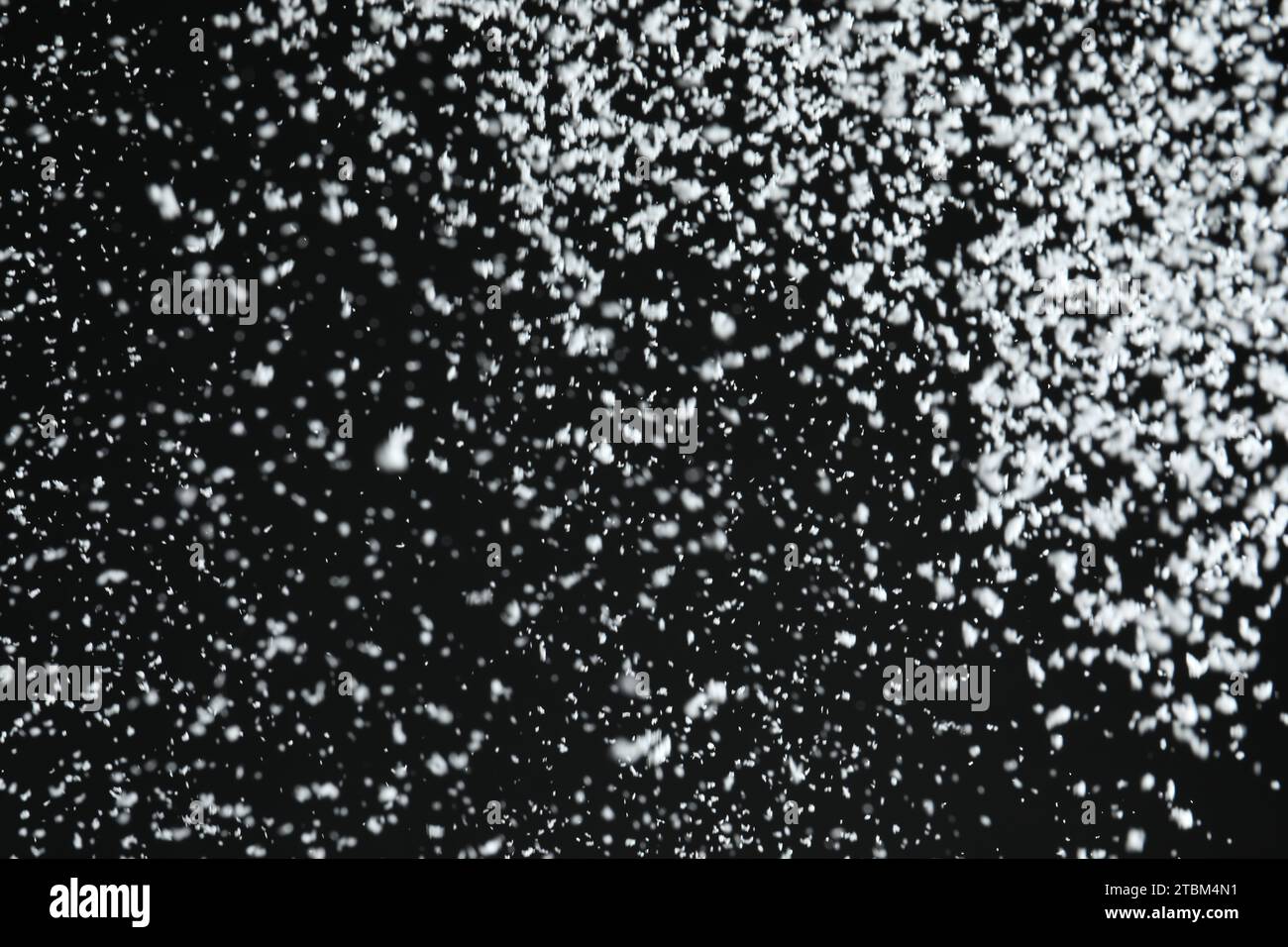 White snow falling down on black background Stock Photo - Alamy