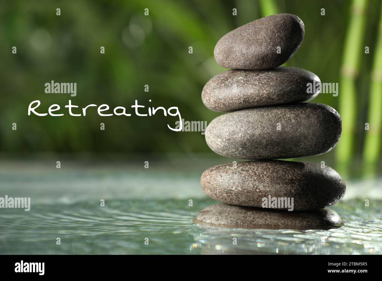 Wellness retreat. Stacked pebble stones in water on blurred background ...