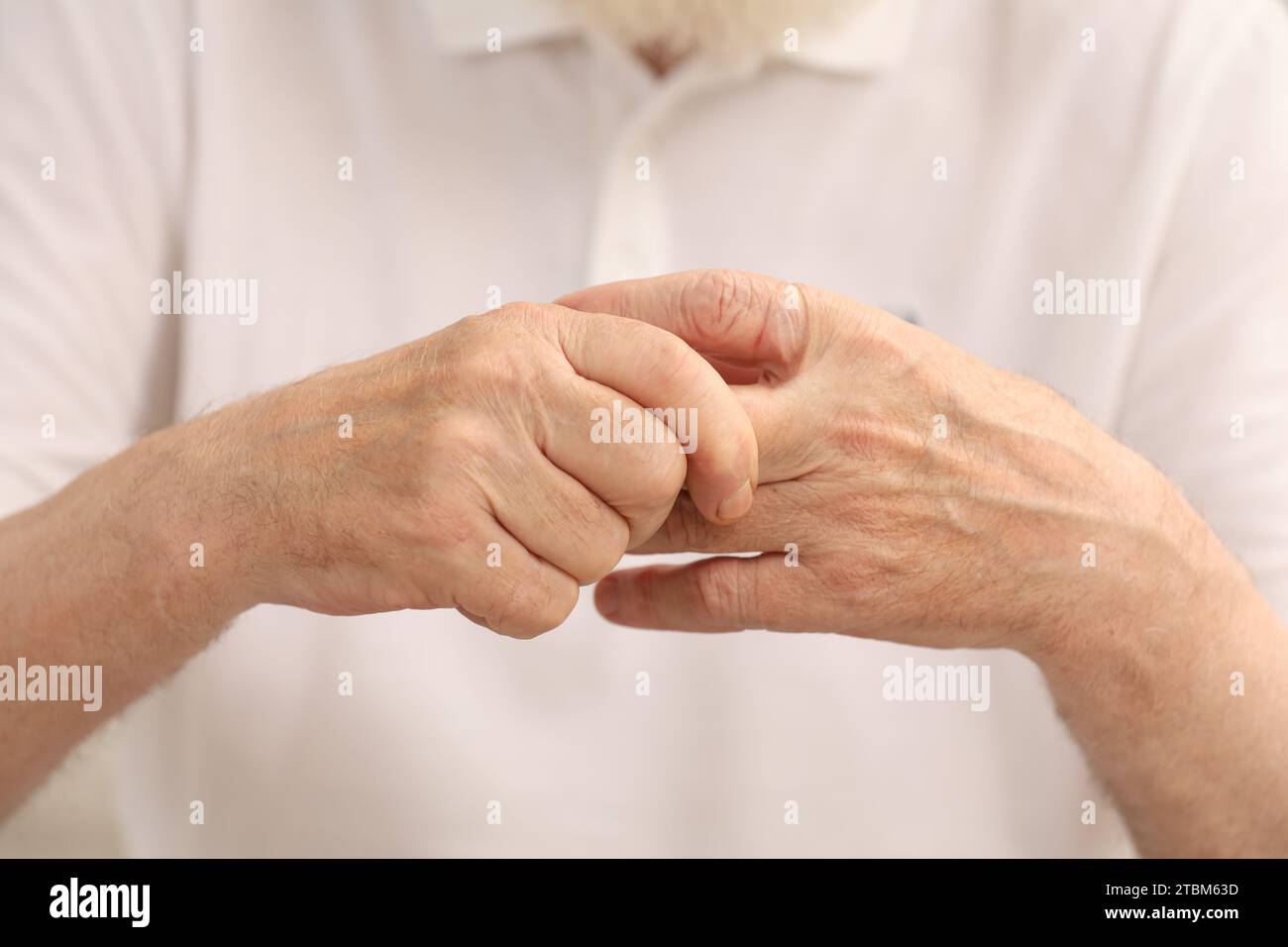 Senior man suffering from pain in hand, closeup. Rheumatism symptom ...