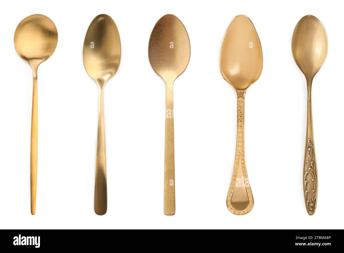 Different stylish golden spoons on white background Stock Photo - Alamy