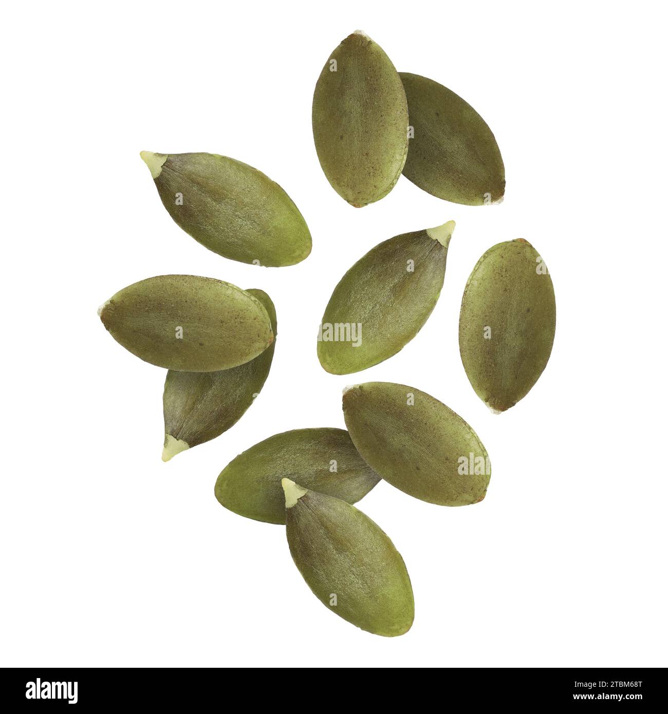 Peeled pumpkin seeds falling on white background Stock Photo - Alamy