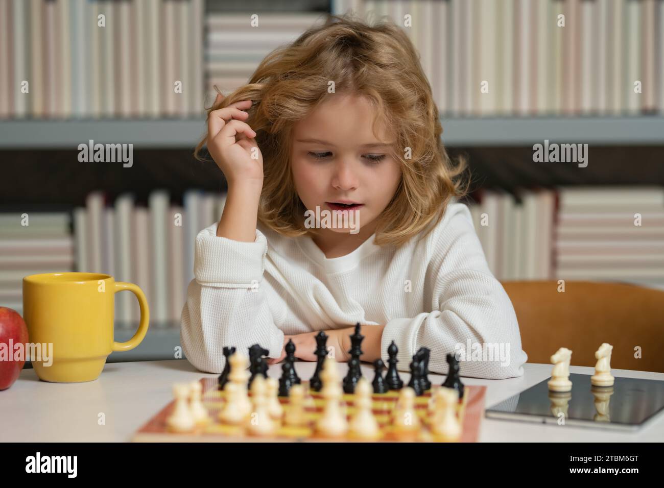 Clever concentrated and thinking child playing chess Stock Photo - Alamy