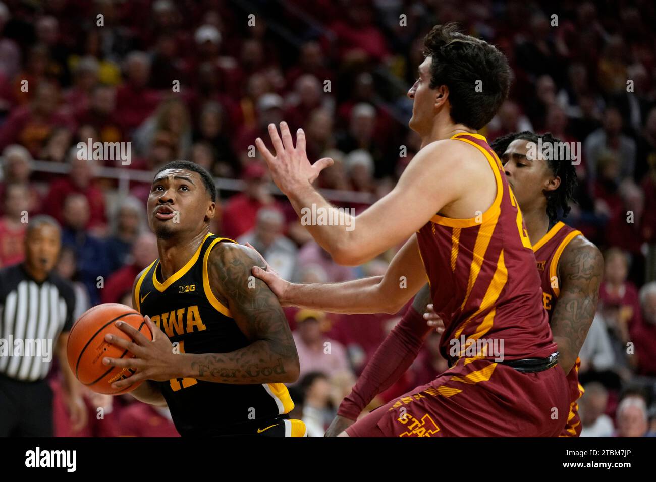 Iowa guard Tony Perkins (11) drives to the basket in front of Iowa ...