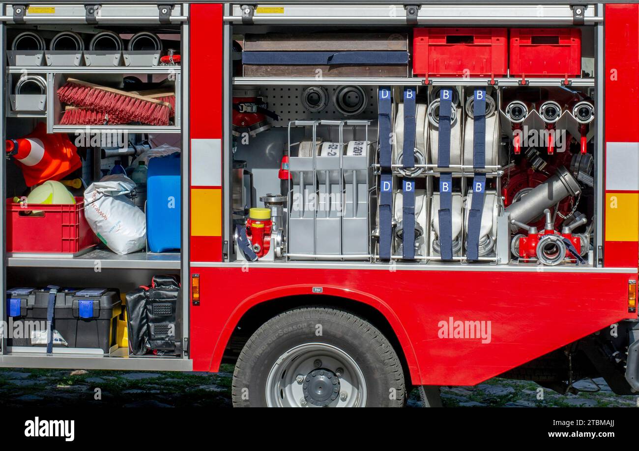 The side view of equipment inside of a fire engine. Fire truck with ...