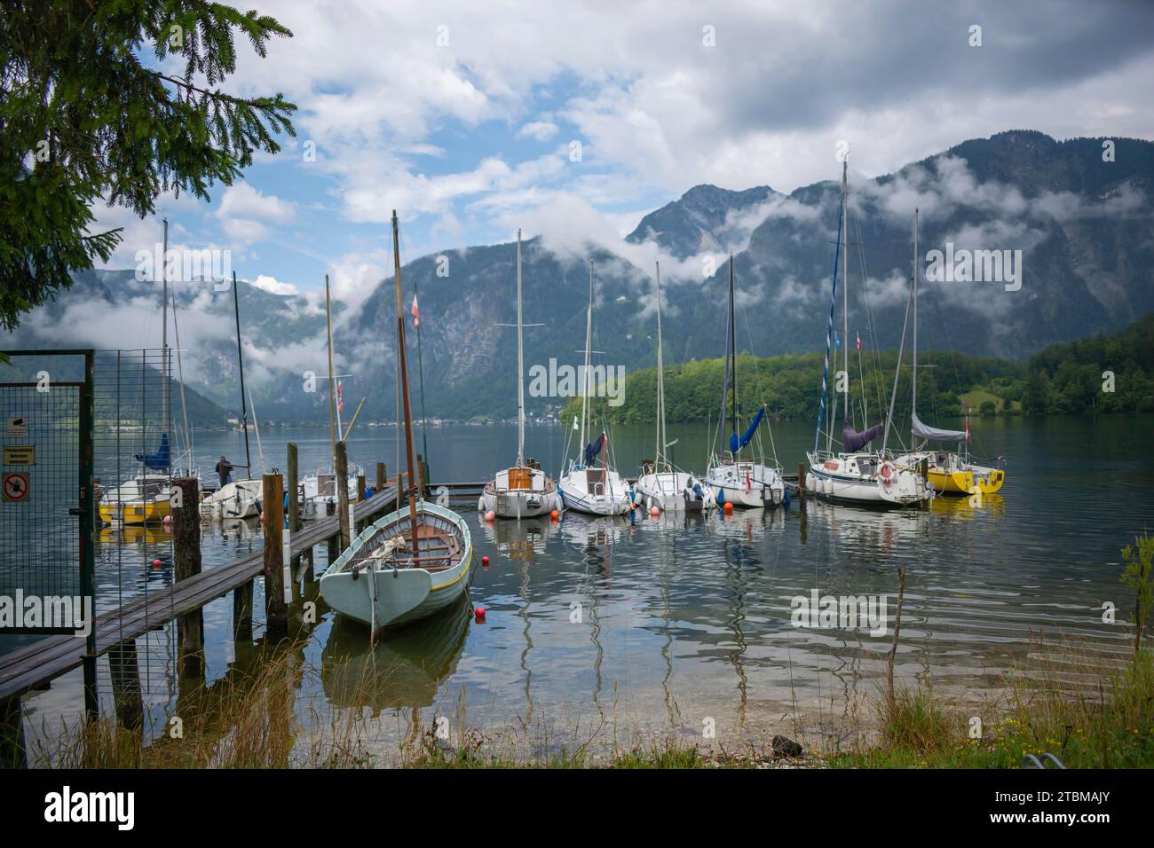 Line of small boats docked at the lake. Row of the small ships. The ...