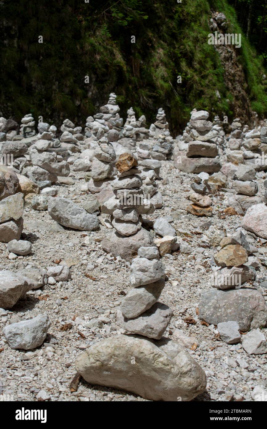 Stone towers and piles of stones on a river bank. Stacked rocks forming ...