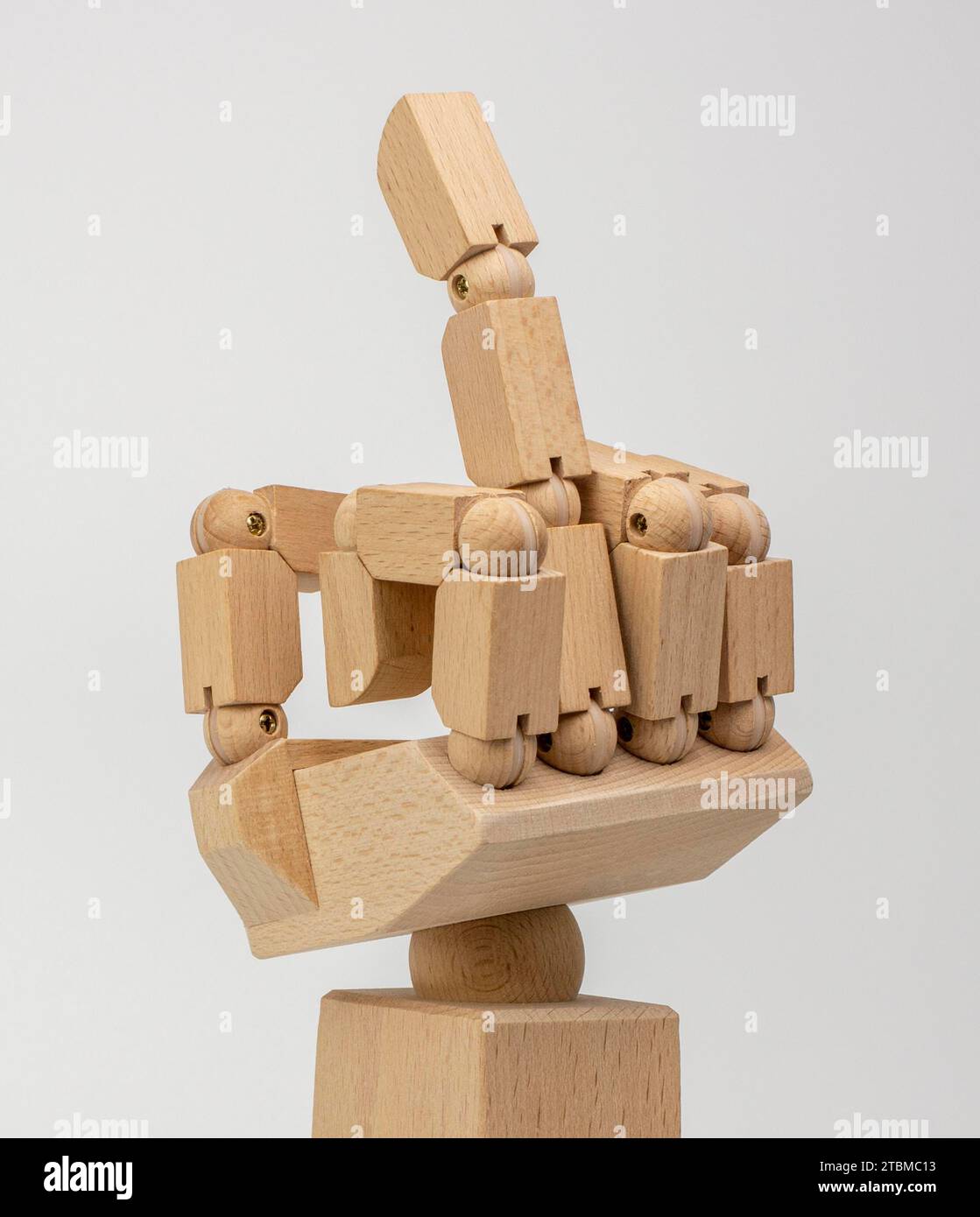 The middle finger gesture. Wooden hand holder showing middle finger ...