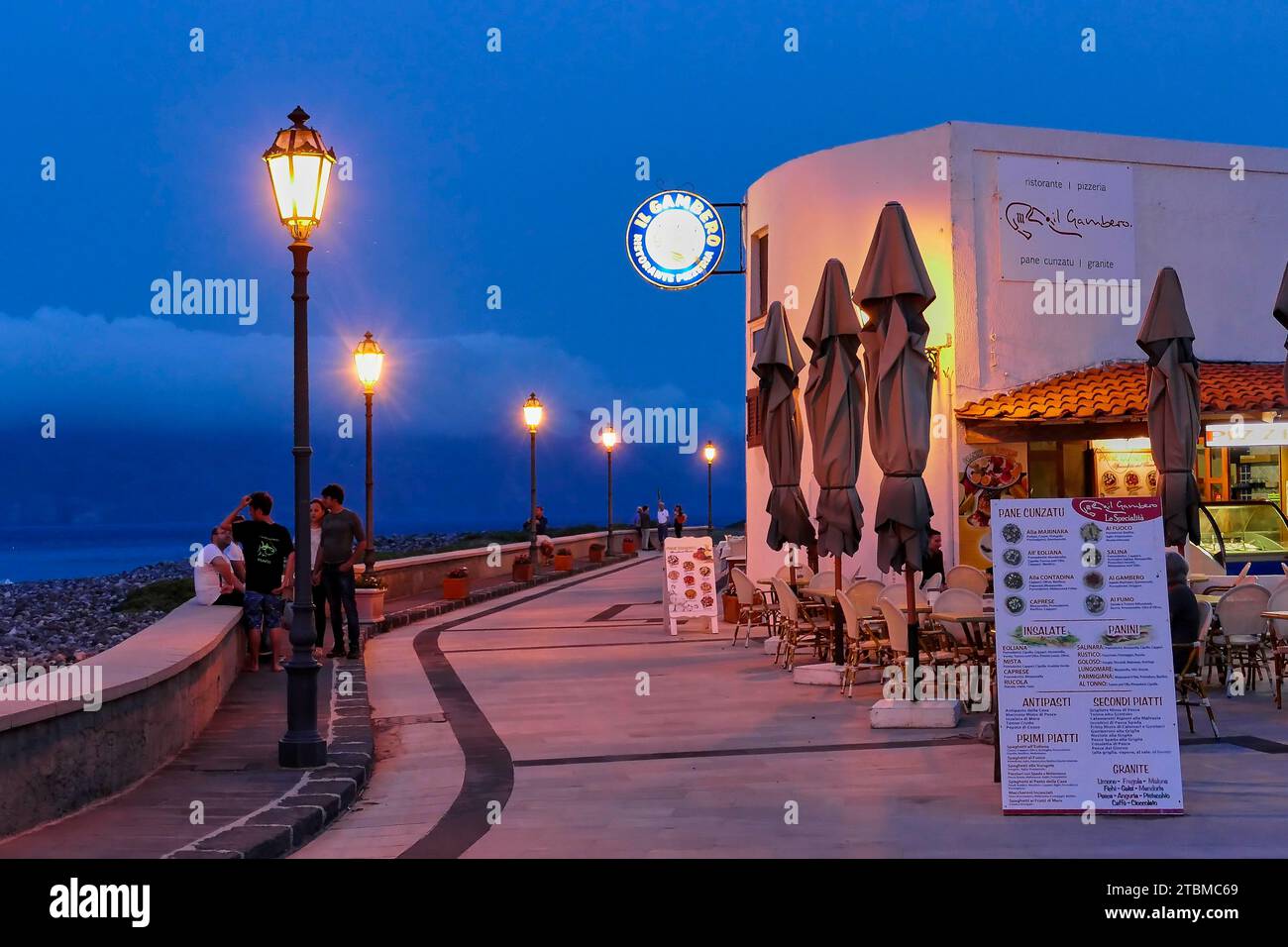 Coastal promenade, young passers-by, lanterns, night blue sky, night ...