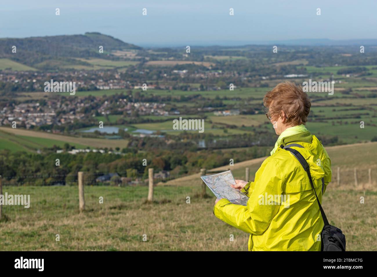 Woman studying map, in the background Upper Beeding and Steyning ...