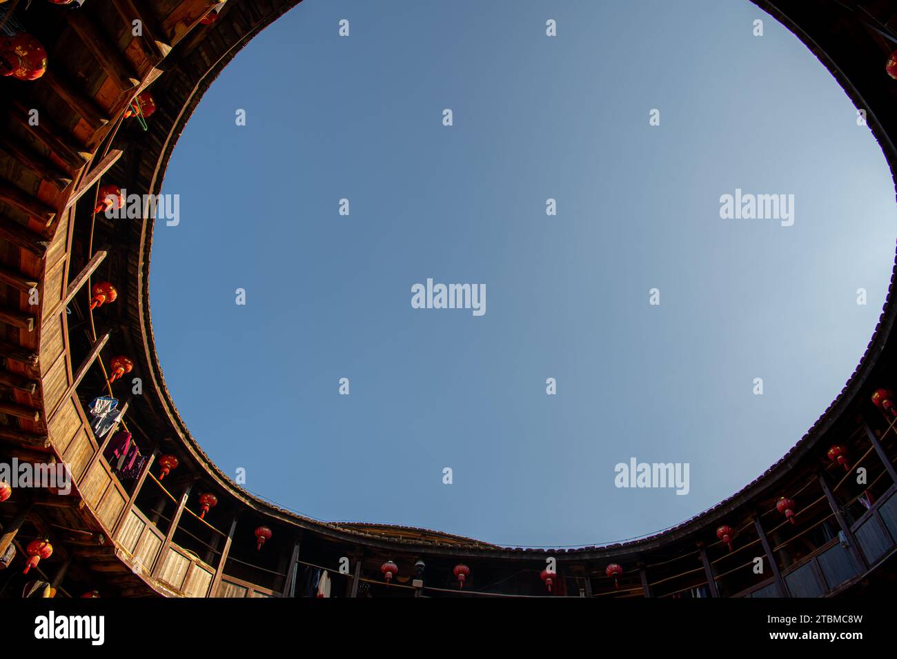 The sky above the round buildings of Hekeng Tulou Cluster in the early ...