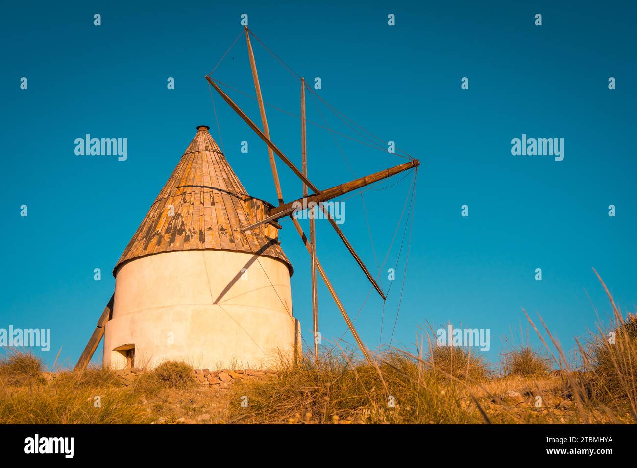 Colorful photo of an ancient windmill during sunset in Cabo de Gata ...
