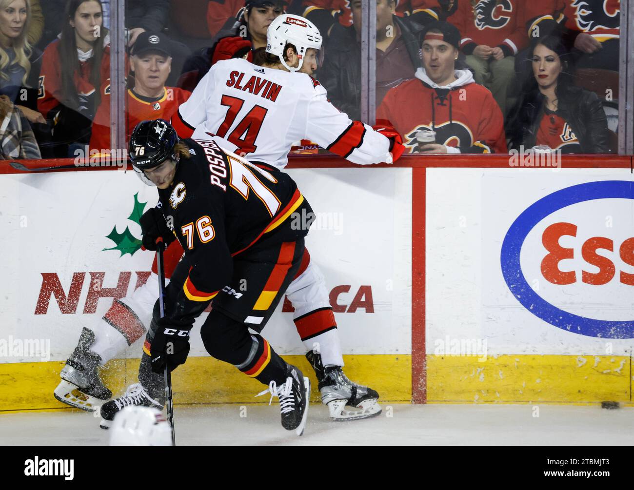 Carolina Hurricanes defenseman Jaccob Slavin, right, is checked by ...