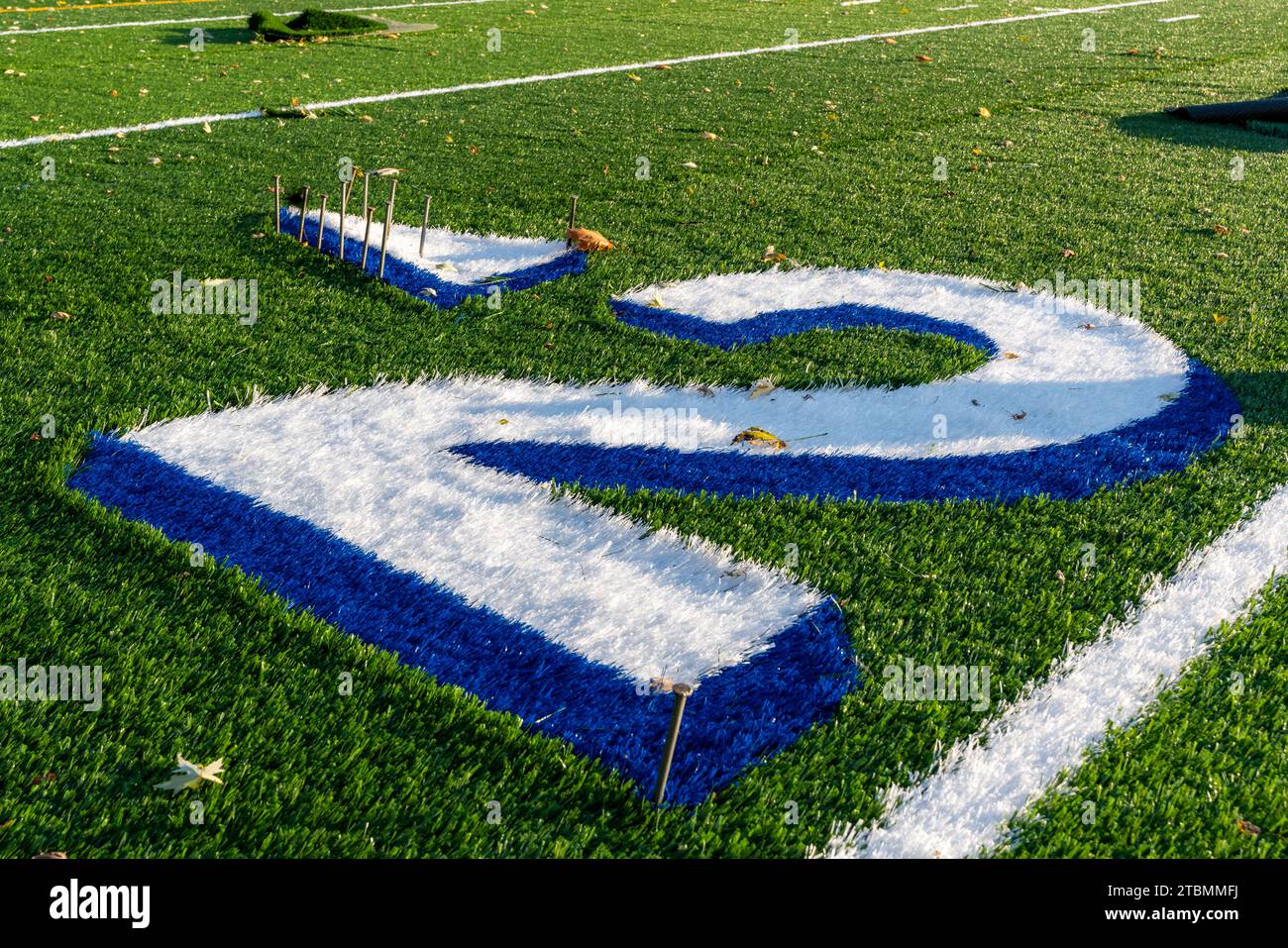 Synthetic turf field under construction with lines and graphics being ...
