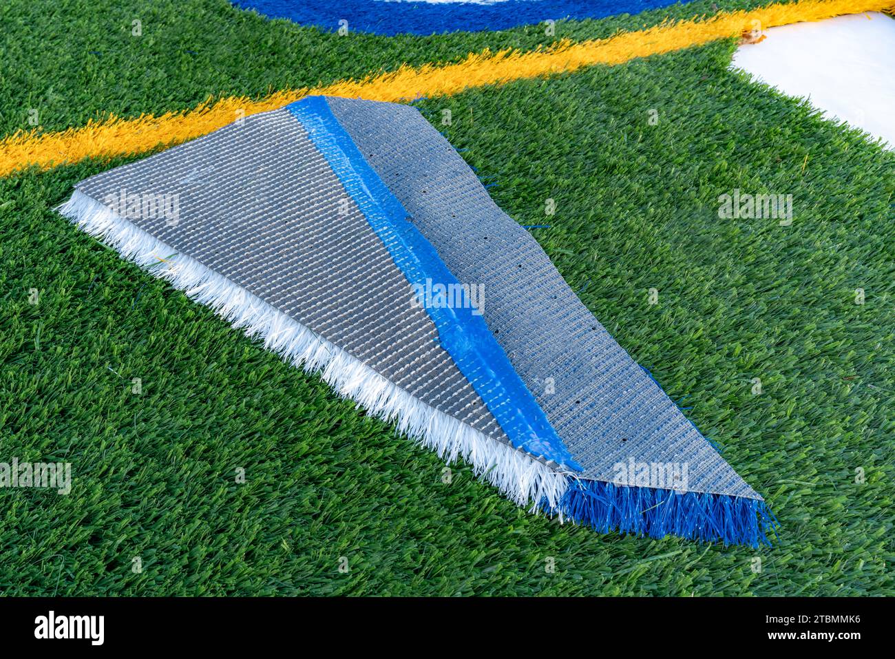 Synthetic turf field under construction with lines and graphics being ...