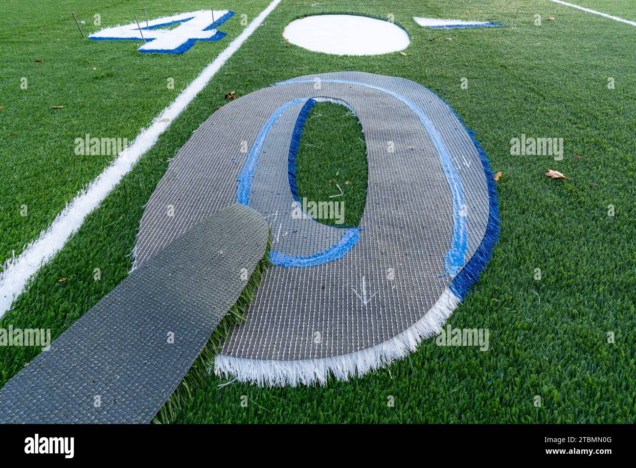 Synthetic turf field under construction with lines and graphics being ...