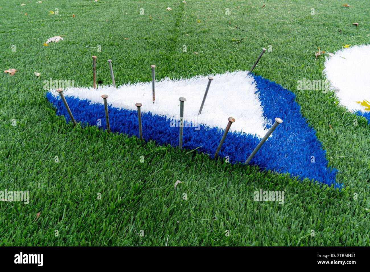 Synthetic turf field under construction with lines and graphics being ...
