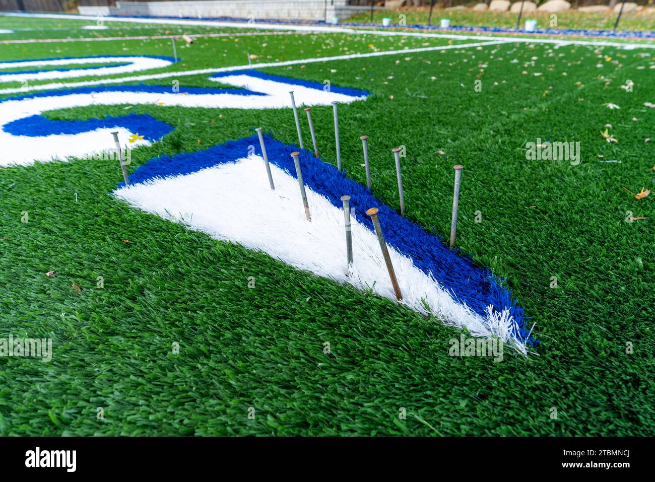 Synthetic turf field under construction with lines and graphics being ...