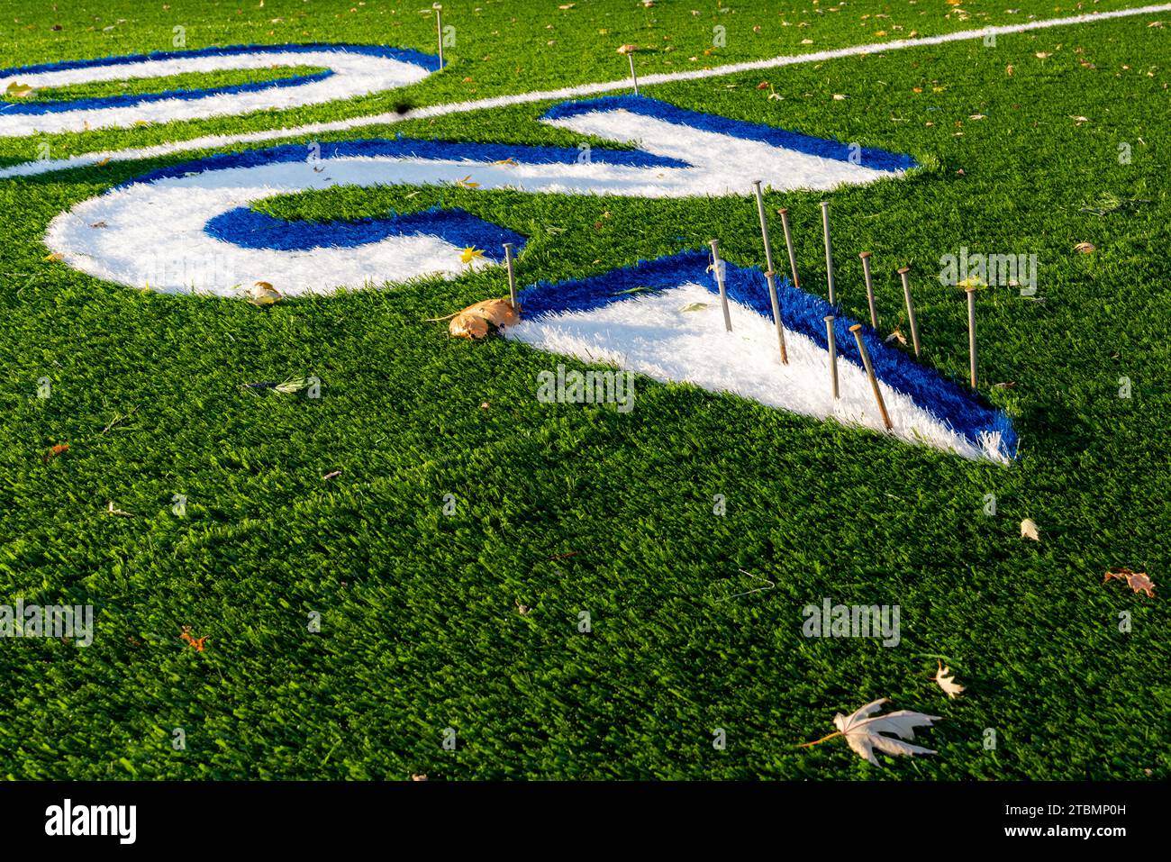 Synthetic turf field under construction with lines and graphics being ...