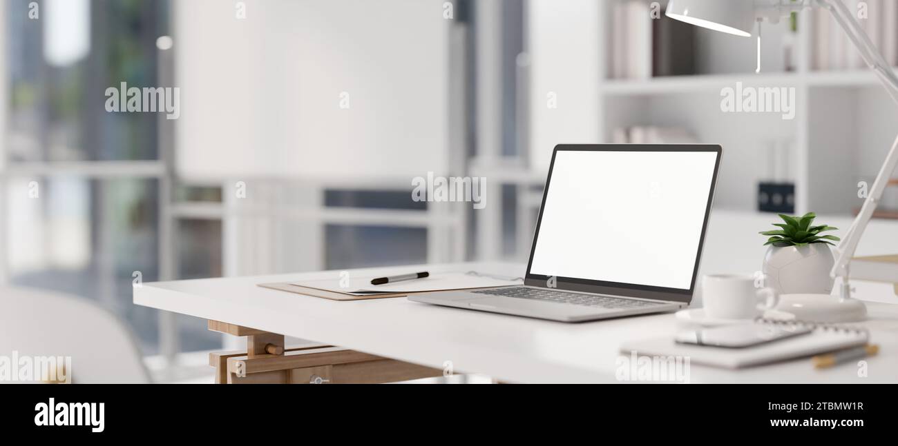 Side view image of a white-screen laptop computer and office supplies ...