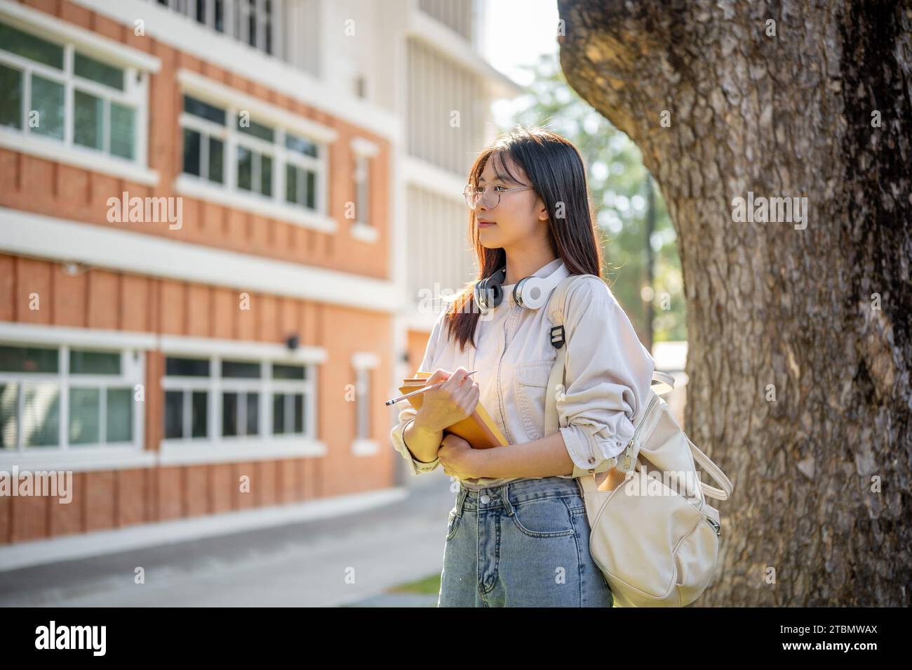 A portrait of a beautiful and positive young Asian female college ...