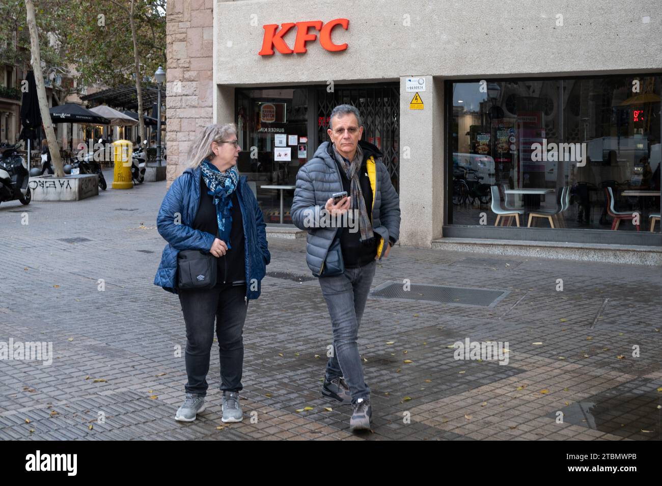 Pedestrians walk past the American fast-food chicken restaurant chain ...
