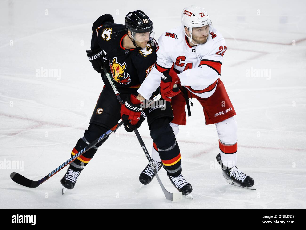 Carolina Hurricanes defenseman Brett Pesce, right, checks Calgary ...