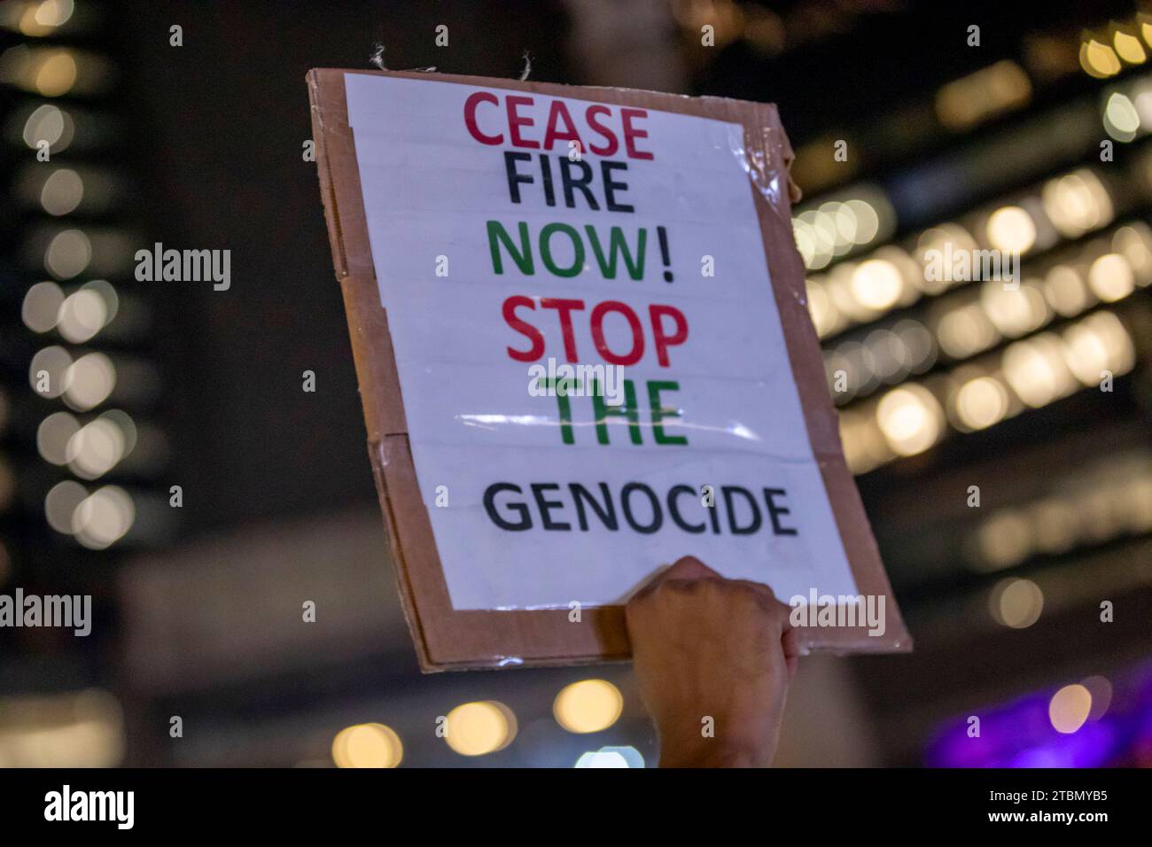 NEW YORK, NEW YORK - DECEMBER 8: A person holds a "Ceasefire now" sign ...
