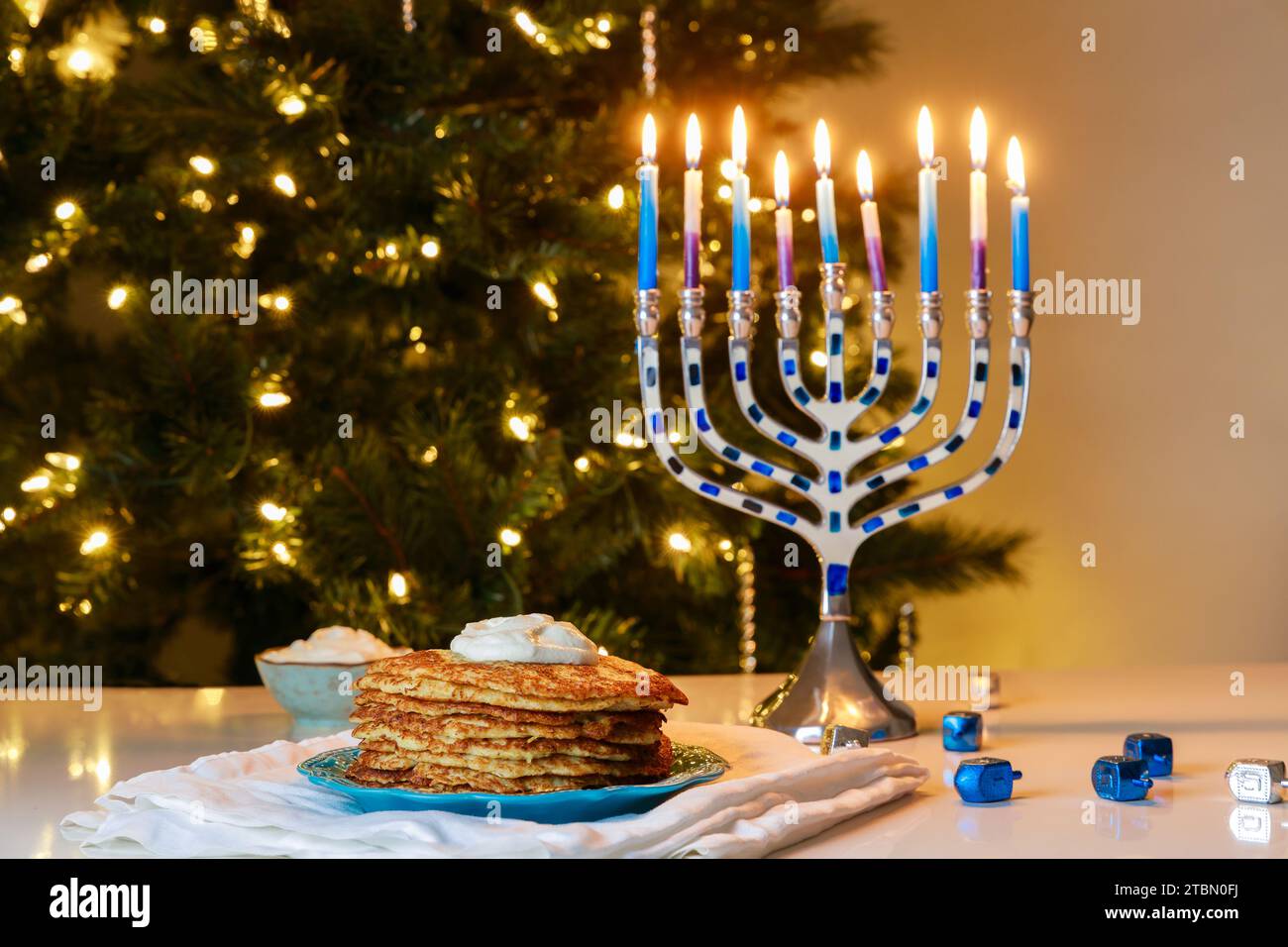 Hanukkah menorah and crispy potato latkes for Jewish holiday dinner ...