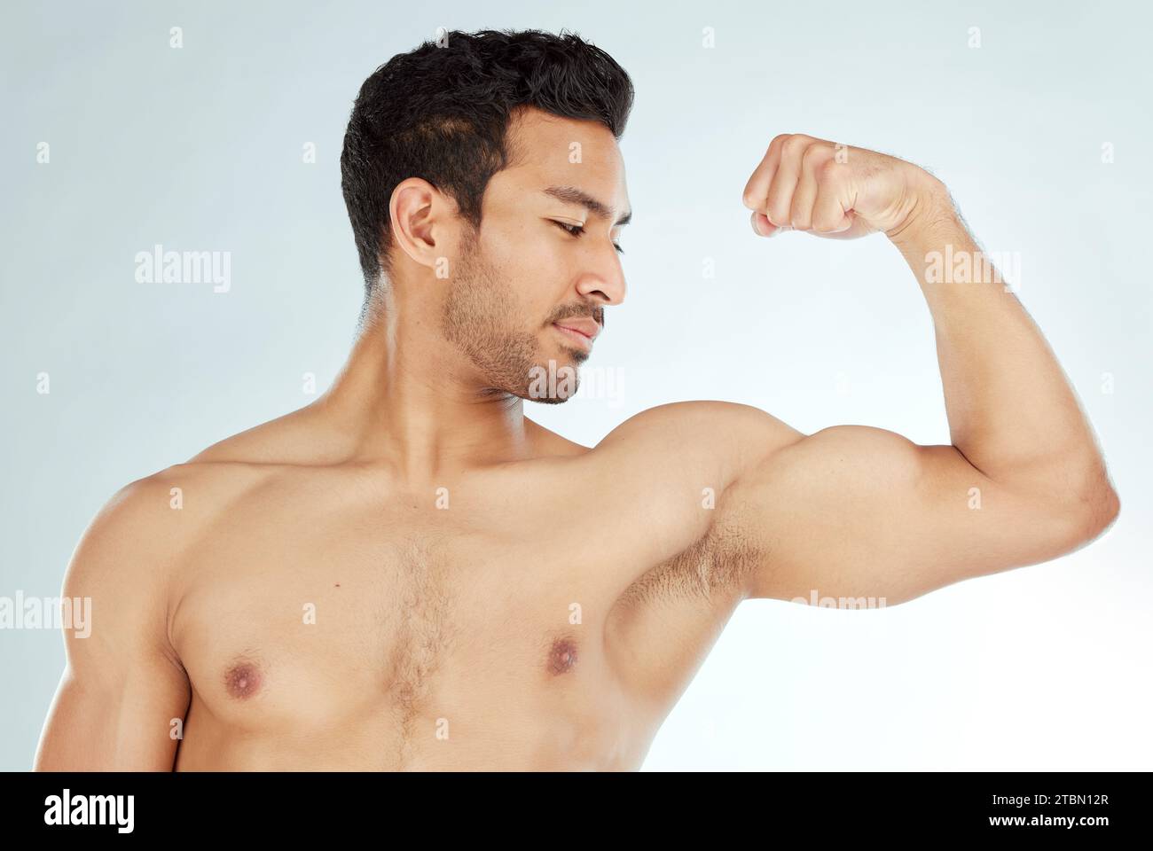 Fitness, bicep flex and asian man in studio for wellness, training or ...